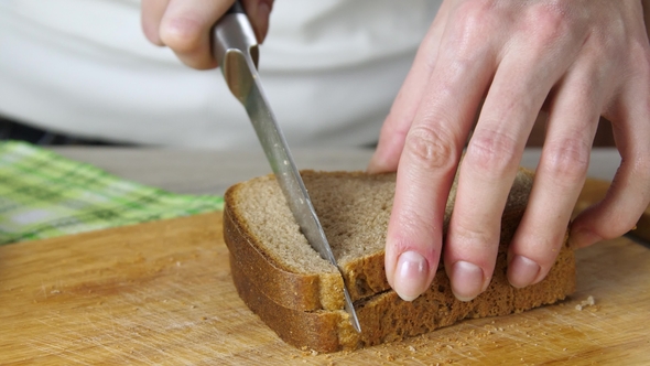 Cutting the Bread into Small Pieces for Making Toast, Stock Footage