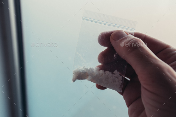 Criminology expert collecting drug evidence at crime scene Stock Photo ...