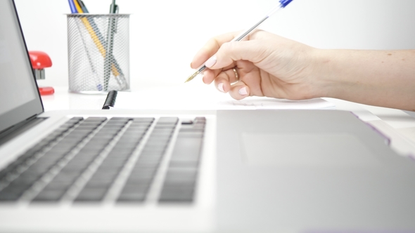 Fingers Typing on a Laptop Keyboard and Writing Something in Notebook ...