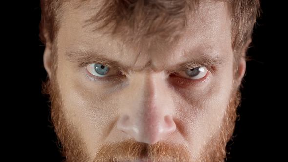 Angry Look of a Young Man in a Studio on a Black Background, Stock Footage