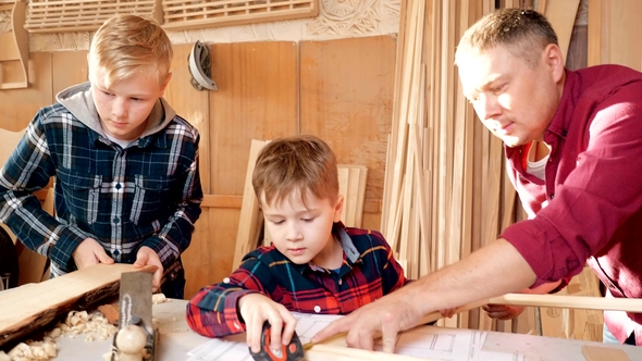 Family, Carpentry, Woodwork and People Concept. Father Teaches Son ...