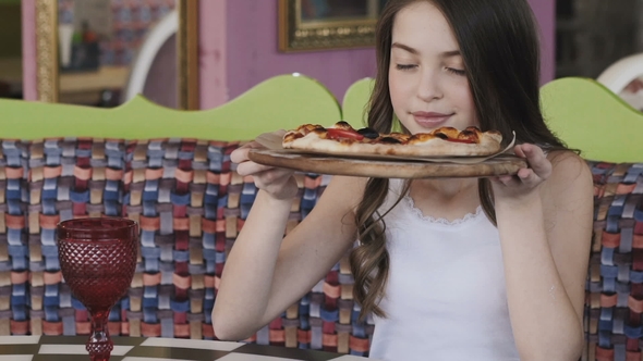 Pretty Young Girl Enjoying the Smell of a Pizza. Slowly, Stock Footage