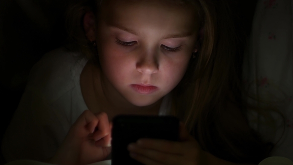 The Child Plays the Game at Night on the Phone, Stock Footage | VideoHive