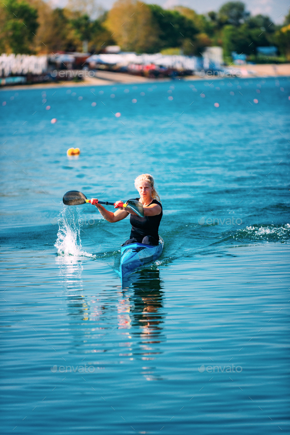 Female athlete in kayak Stock Photo by microgen | PhotoDune