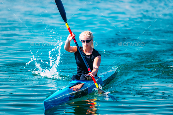 Female athlete in kayak Stock Photo by microgen | PhotoDune