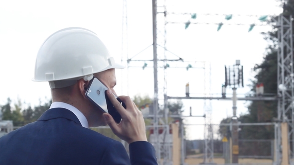 Angry Engineer Screaming on the Phone against a Power Plant Background ...