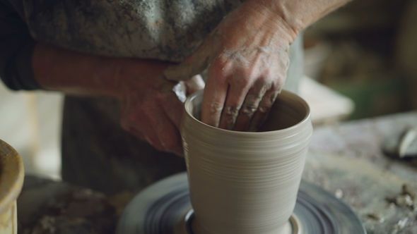 Shot of Male Hands Smoothing Molded Clay Pot with Wet Sponge on ...