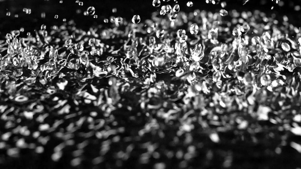 Strong Vibration Lifts the Water Drops Up. Black Background., Stock Footage