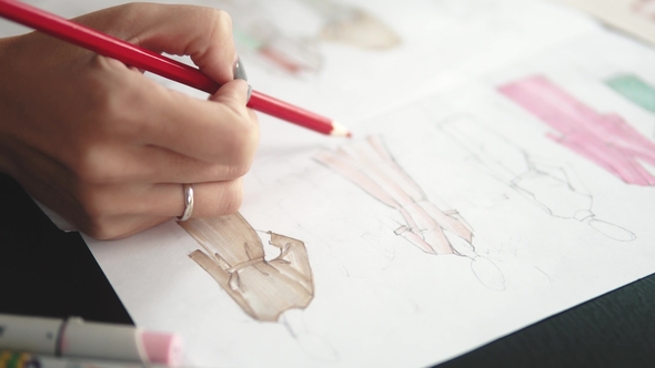 Designer of Clothes Makes an Outline of Clothes with a Felt-tip Pen ...