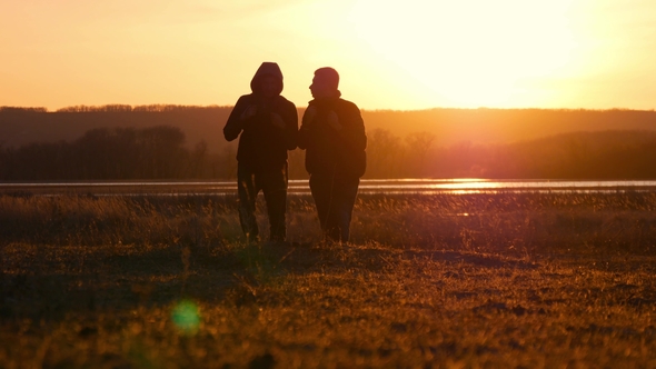 Two Best Friends Holding Hands In The Sunset