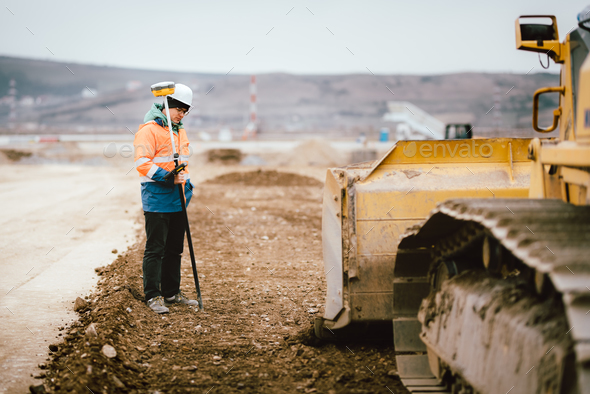 Geodesy details - construction site workers building highway and roads ...