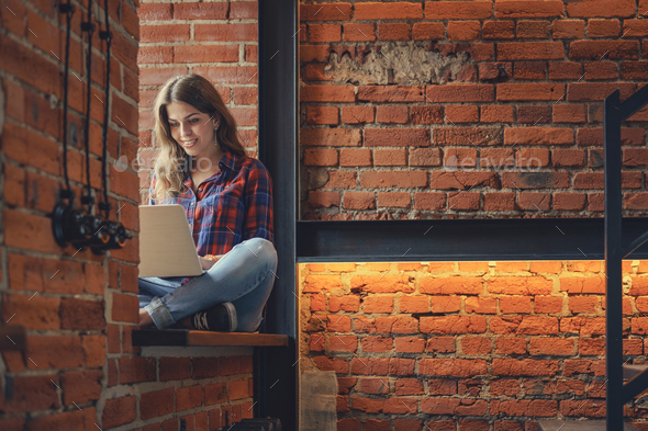 Young smiling woman in the loft Stock Photo by AboutImages | PhotoDune