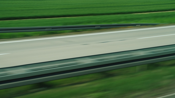 Quickly Go By Motorway, Which Passes Through Green Fields, Stock Footage