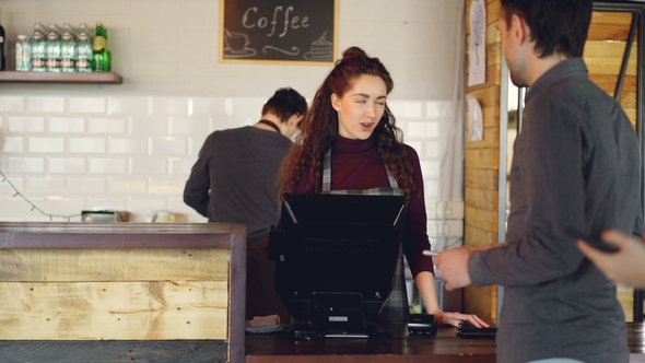 Attractive Woman Talkative Cashier Is Accepting Contactless Payments ...