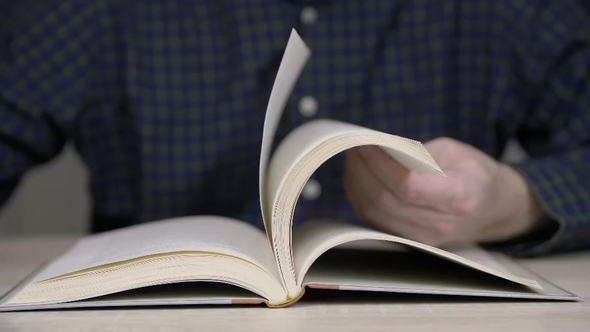 Man Flipping Pages in Book for Browsing Close Upf. Browsing Pages in ...