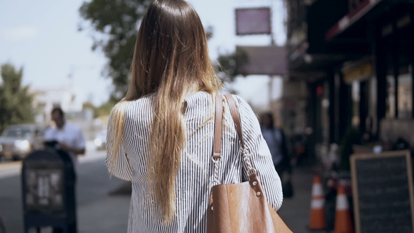 Back View of Young Beautiful Woman Walking Through the City Centre in ...