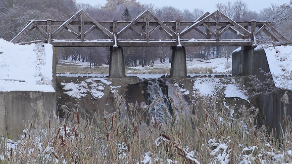 Little Waterfall Under the Bridge on the Background of Lake and Some ...