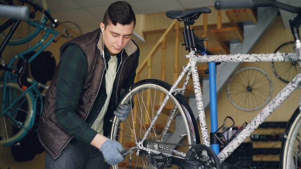 Experienced Mechanic Assembling Bicycle Adjusting Back Wheel during ...