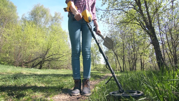 Girl Treasure Hunter with Metal Detector and Shovel Looking for ...