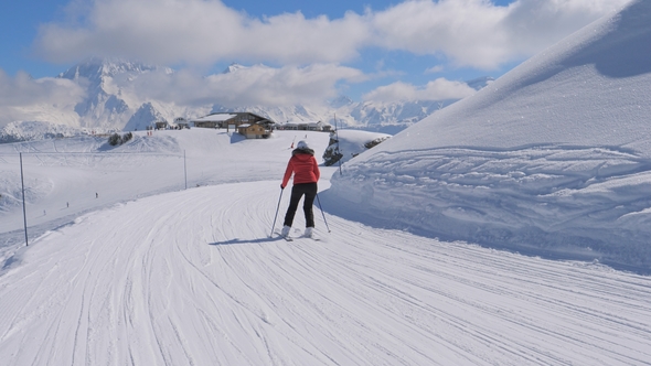 Woman Skis and Turns Down the Run on the Slope at a Mountain Ski Resort ...