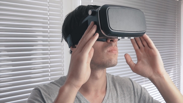 Young Man Using His VR Headset for Watching the 360 Video at Office ...
