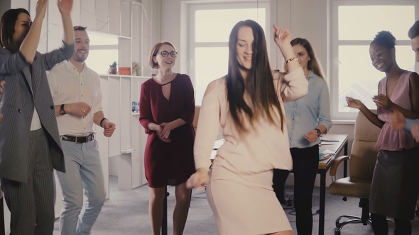 Happy Caucasian Female Executive Doing Funny Victory Dance. Mixed Race ...