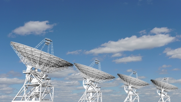 Satellite Dishes Moving in Against a Cloudy Sky, Motion Graphics ...
