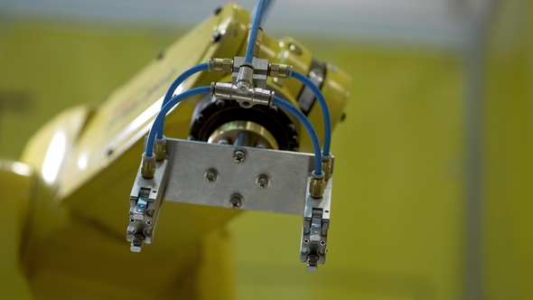 Yellow Industrial Robot Manipulator Performs Movements That Are ...