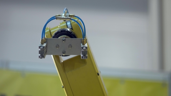 Yellow Industrial Robot Manipulator Performs Movements That Are ...