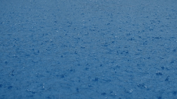 Heavy Rain on Blue Water. Drops Falling and Splash., Stock Footage