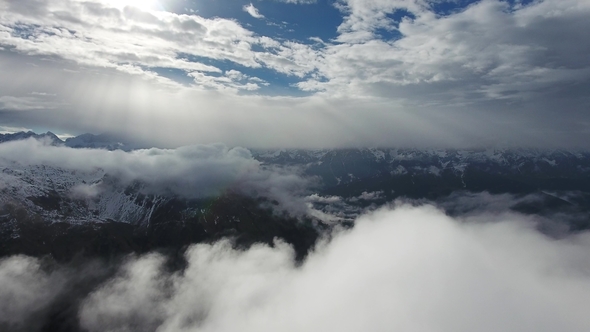 Flying Through Clouds Between Snow Mountains, Stock Footage | VideoHive