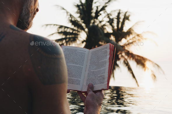Man reading a book in the swimming pool Stock Photo by Rawpixel | PhotoDune