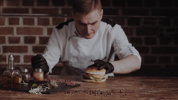 Chief Cook Preparing Fresh Burger in the kitchen.Burger Restaurant Menu ...