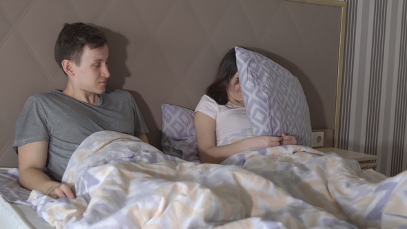 Difficulties in the Relationship as Young Man and Woman Swearing in Bed ...