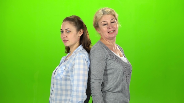 Two Women Stand Back To Back and Cross Their Arms. Green Screen, Stock ...