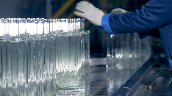 Glass-house Employee Is Moving Glass Bottles Along the Transporter ...