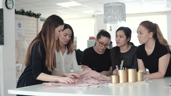 Fashion Designer and His Assistants Choose Fabric for the Dress and ...