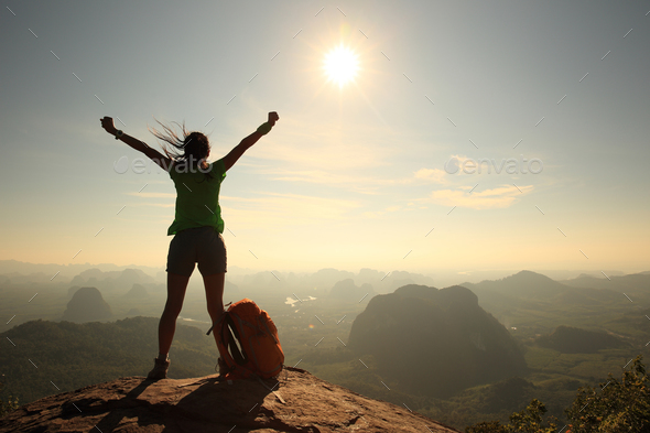 Cheering for see the first sight sunshine on mountain top Stock Photo ...