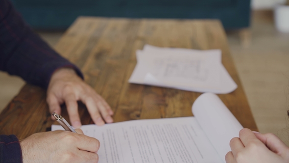 Shot of Male Hand Signing Buy and Sell Contract and Getting House Keys ...