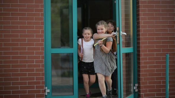 Four Pupils Are Having Fun After School Lessons. They Wear School ...