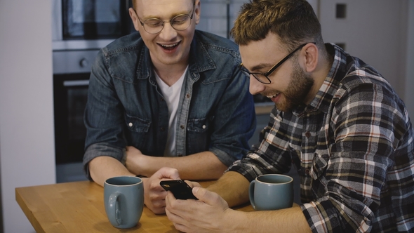 Two Guys Using Entertainment App and Laugh. Happy Young Caucasian ...