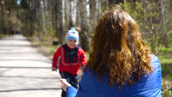 The Child Runs To His Mother, Gently Hugs Her. Happy Family, Loving ...