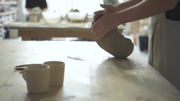 Young Potter Is Kneading Clay Mass on Table in Pottery Workshop., Stock ...