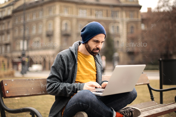 Man using a laptop outdoor Stock Photo by ollyi | PhotoDune