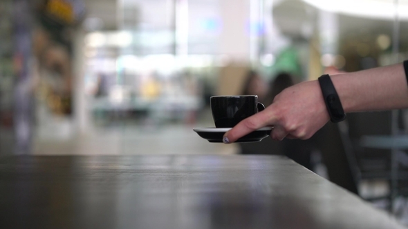 Hand Putting a Black Cup on the Table, Stock Footage | VideoHive