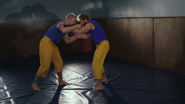 Two Free Fighters Training Kicks and Receptions in the Gym, Stock Footage