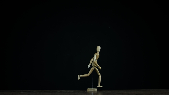 Running Wooden Figure Dummy Rotates in Studio on Black Background ...