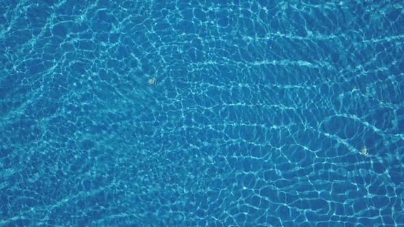 Pure Blue Water in the Swimming Pool with Light Reflections. Aerial ...