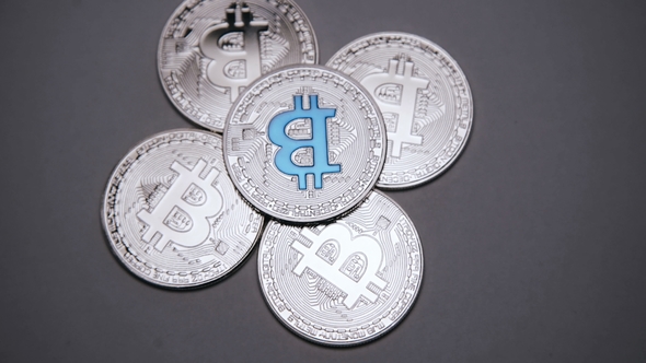 Cryptocurrency, Silver Bitcoins Rotating on the Grey Background, Stock ...