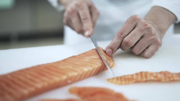 Cook Making Thin Fish Slices in a Sushi Restaurant, Pan Shot, Stock Footage